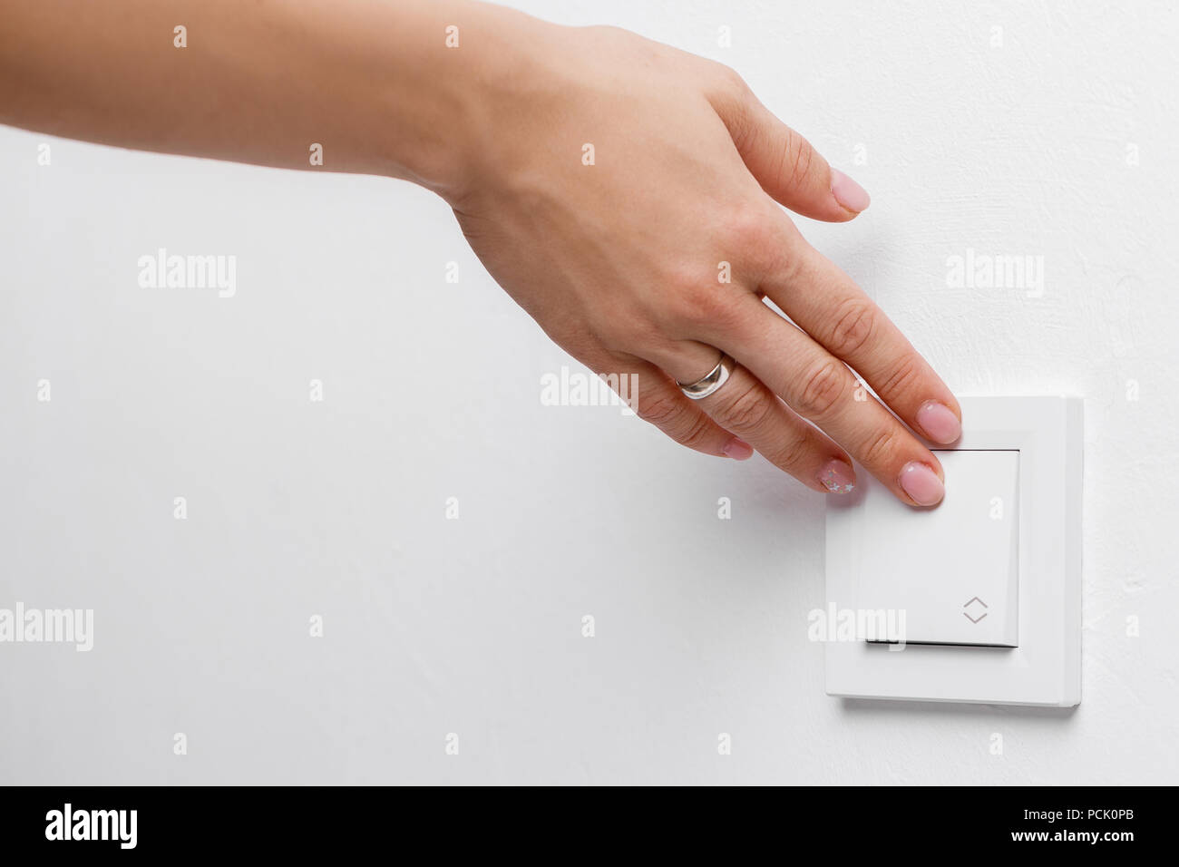 finger turning off light switch Stock Photo - Alamy
