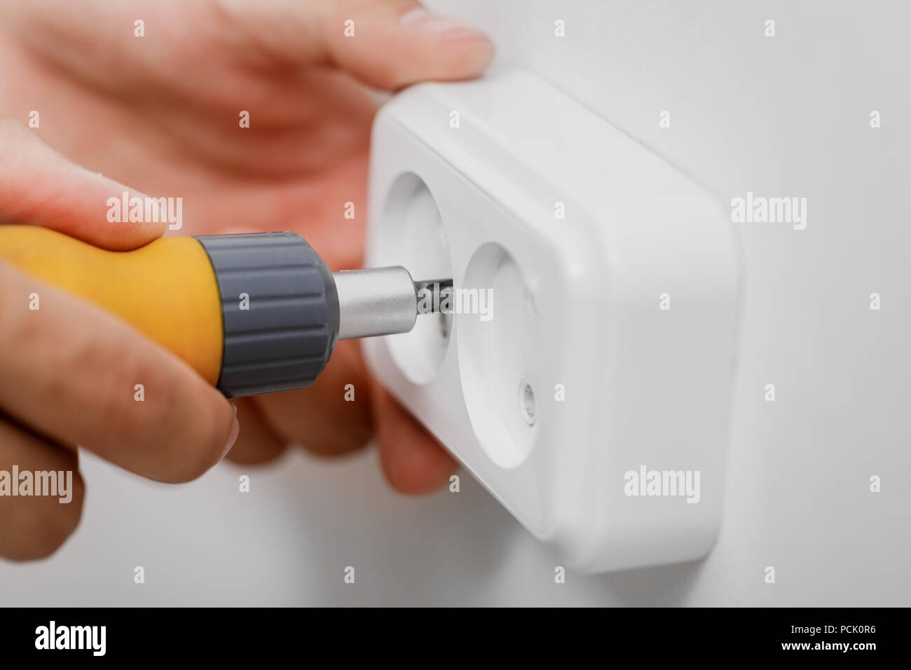 electrician installing electrical socket Stock Photo - Alamy