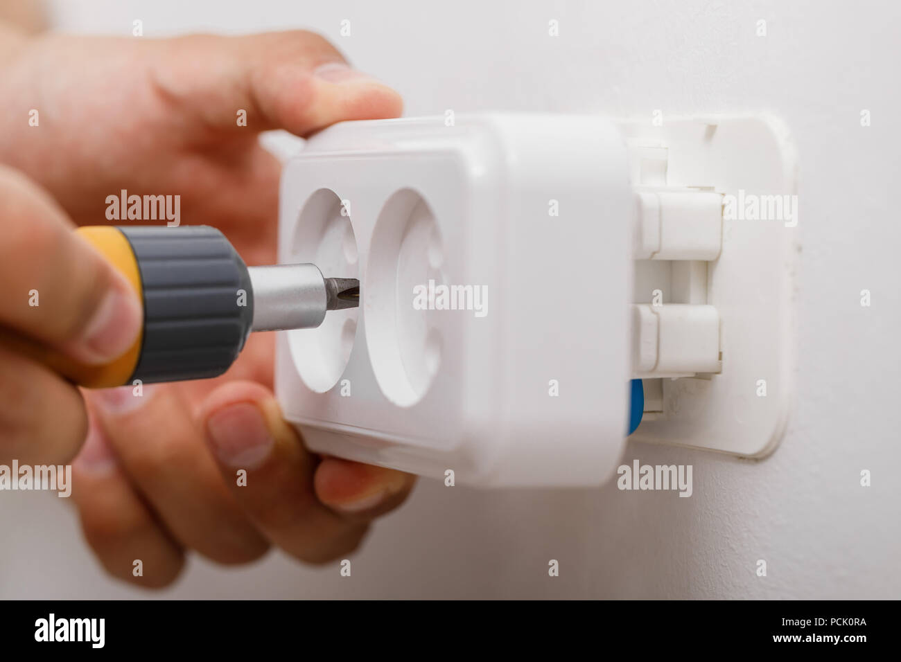 electrician installing electrical socket Stock Photo - Alamy