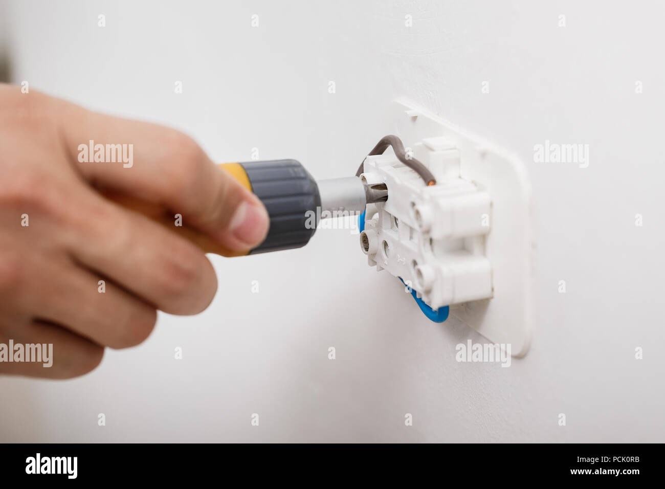 electrician installing electrical socket Stock Photo - Alamy