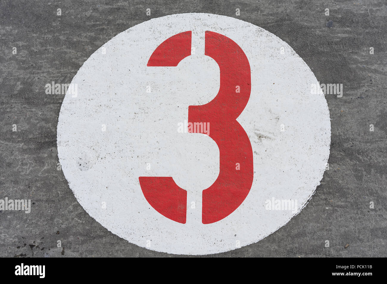 red number in white circle road sign direction on concrete Stock Photo ...