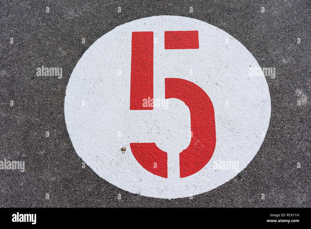 red number in white circle road sign direction on concrete Stock Photo ...
