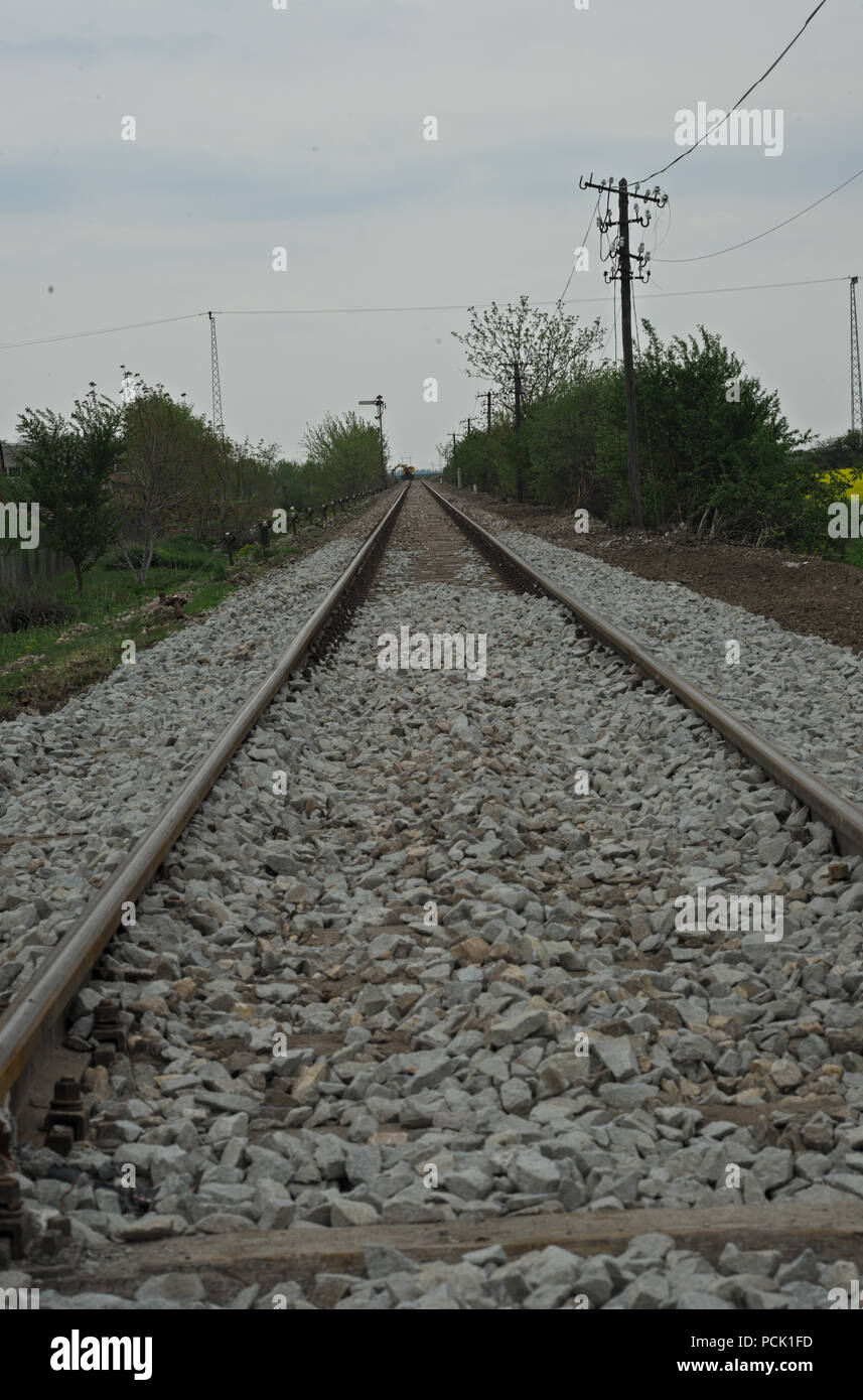 Railway tracks with white stones covering it Stock Photo - Alamy