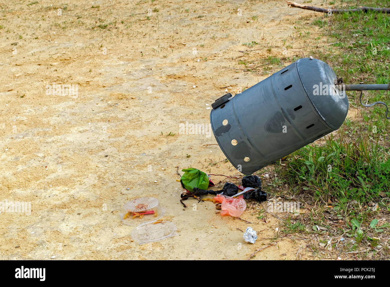 garbage can overturned Stock Photo - Alamy