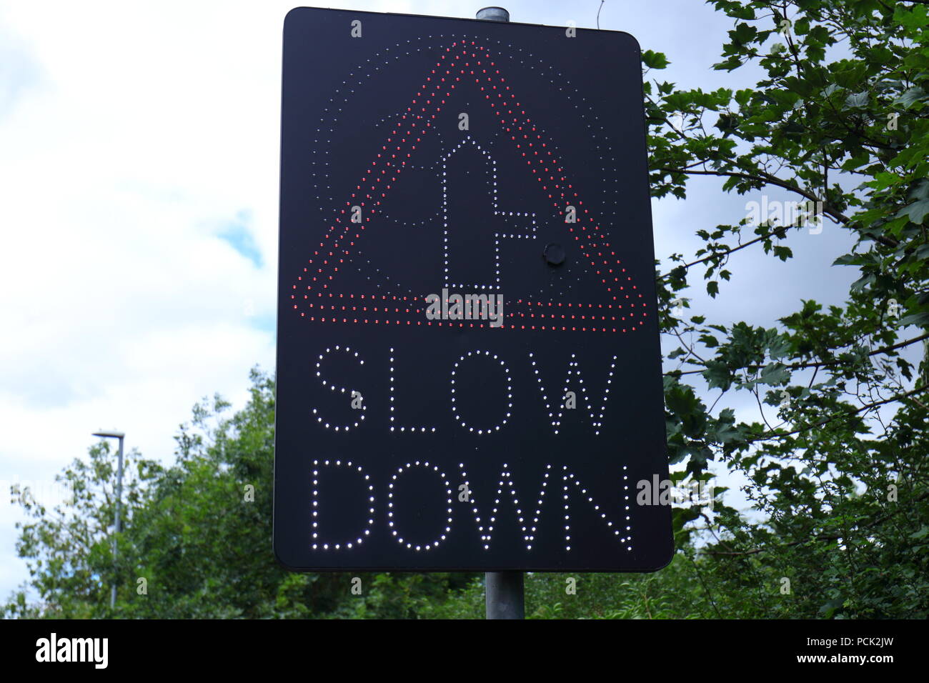 A speed safety sign that warns speeding drivers of the speed limit ...