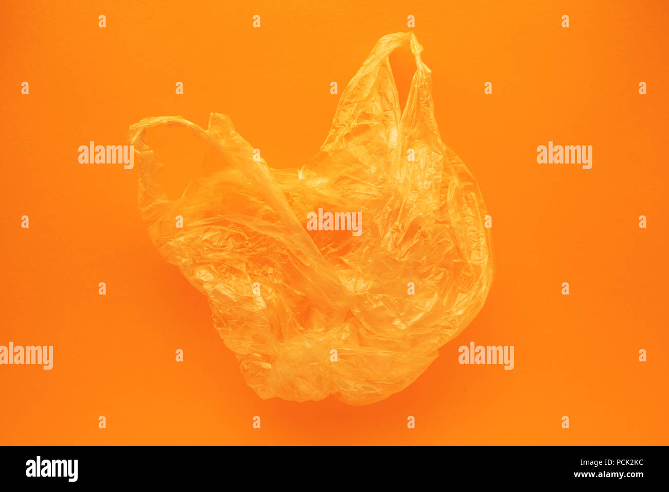 Orange plastic bag, environmental pollution conceptual background image ...