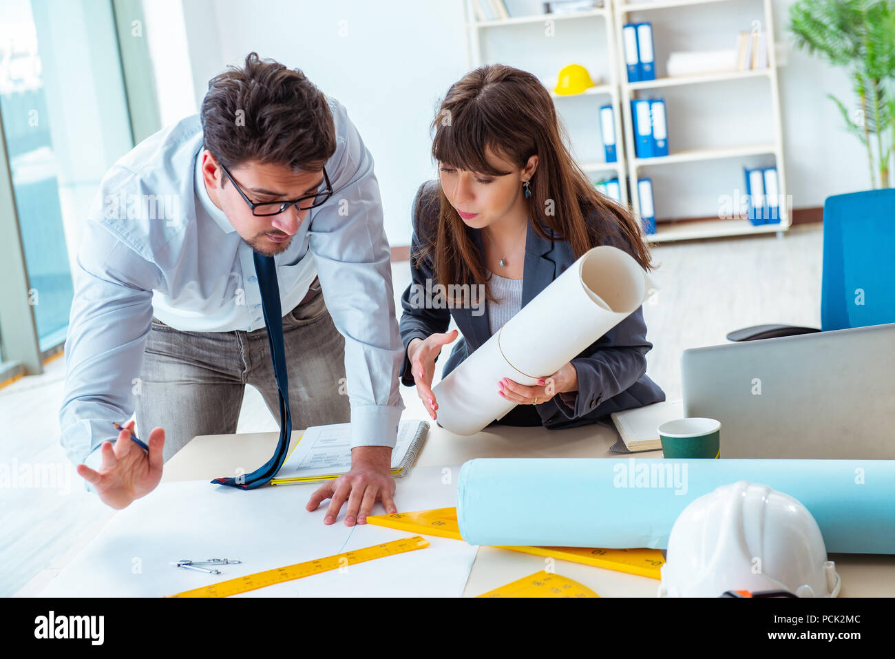 Engineers studying blueprint table hi-res stock photography and images ...