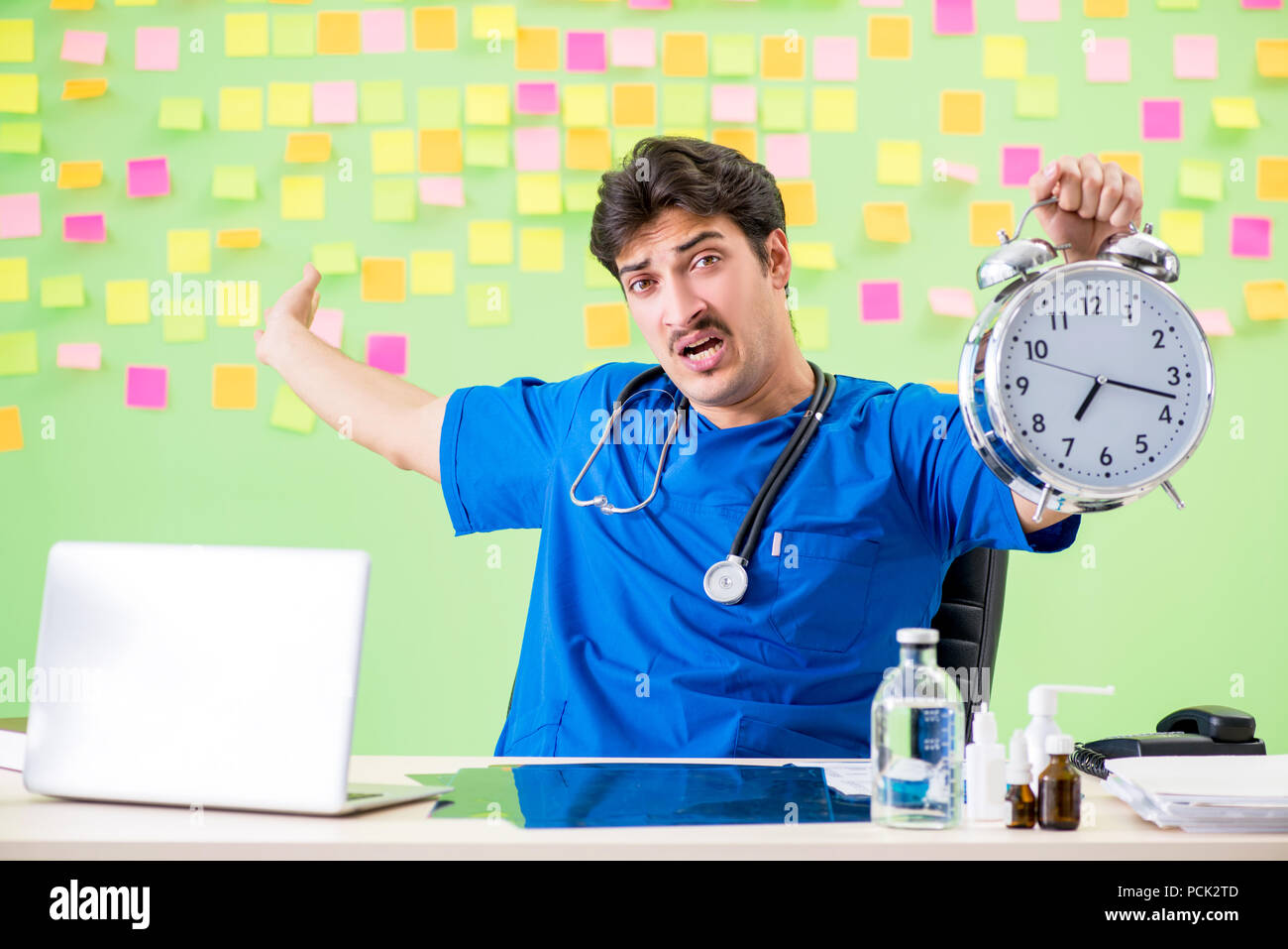 Young doctor with many reminders and urgent work Stock Photo - Alamy