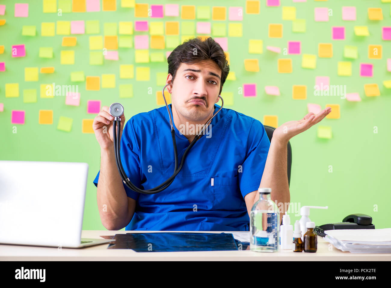Young doctor with many reminders and urgent work Stock Photo - Alamy