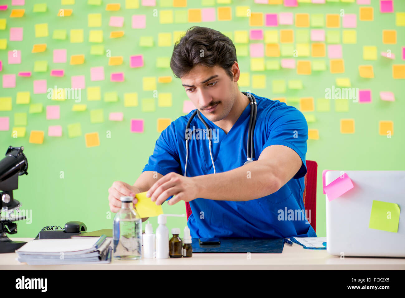 Young doctor with many reminders and urgent work Stock Photo - Alamy