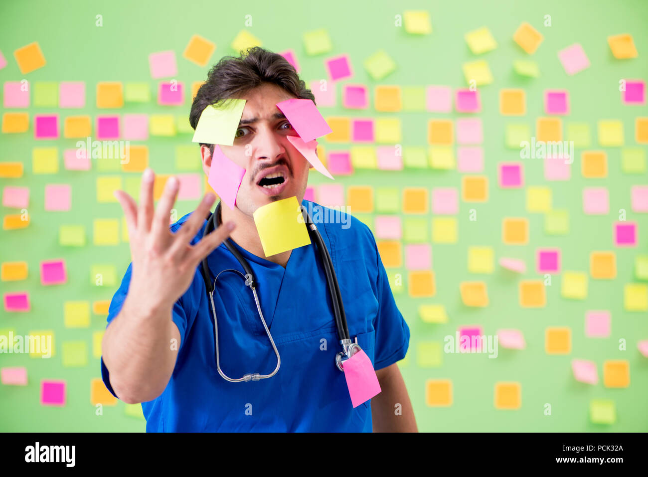 Young doctor with many reminders and urgent work Stock Photo - Alamy