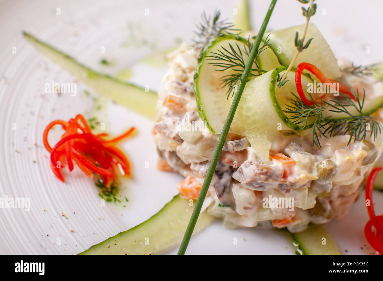 Russian traditional salad Olivier with vegetables and meat. Salad on a ...