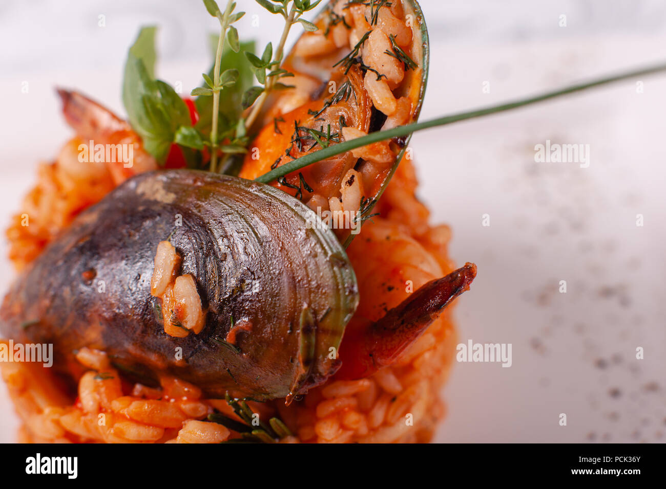 Italian Risotto with seafood, grilled prawns, mussels in a shell ...