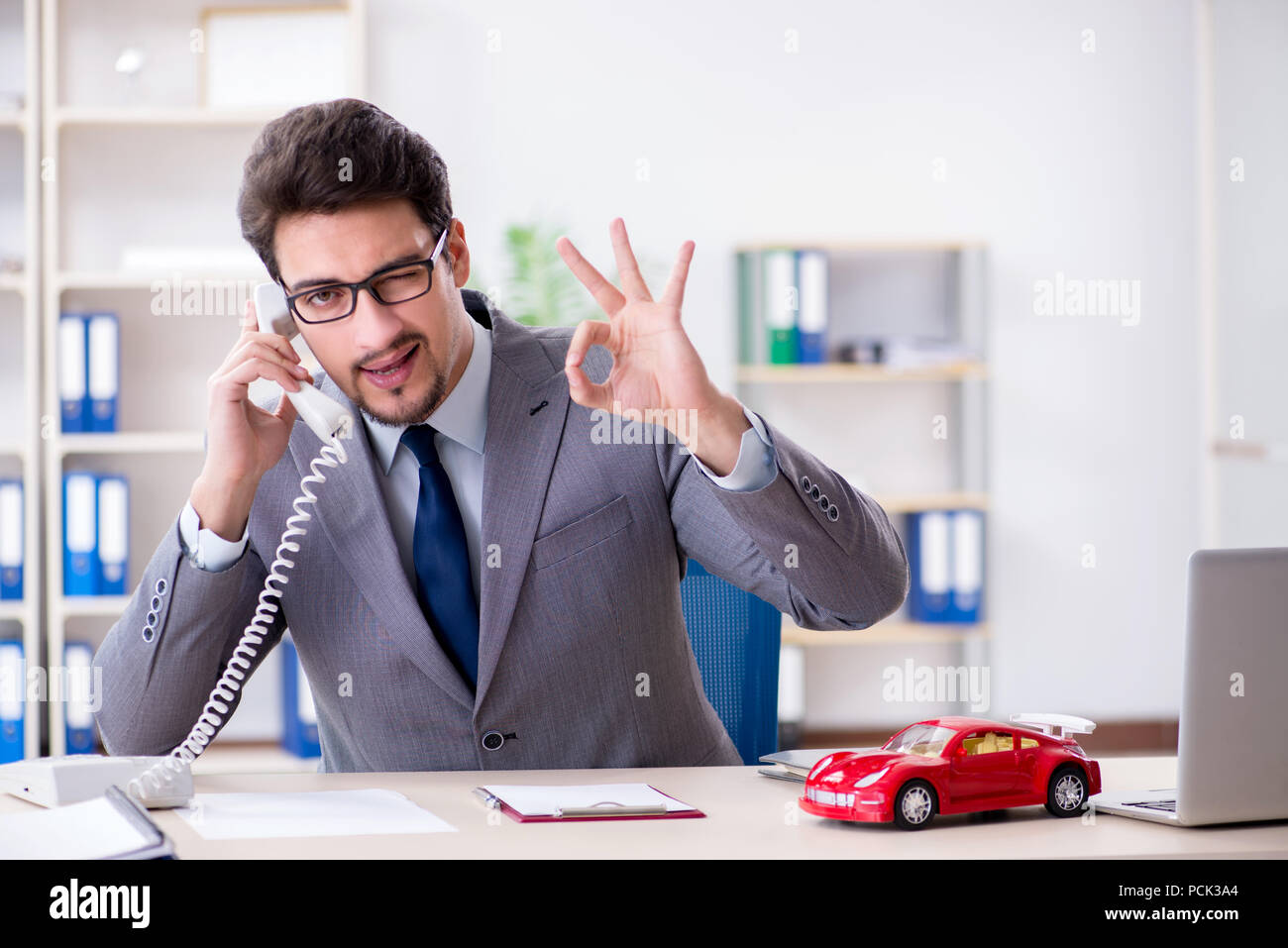 Agent offering car motor insurance Stock Photo - Alamy