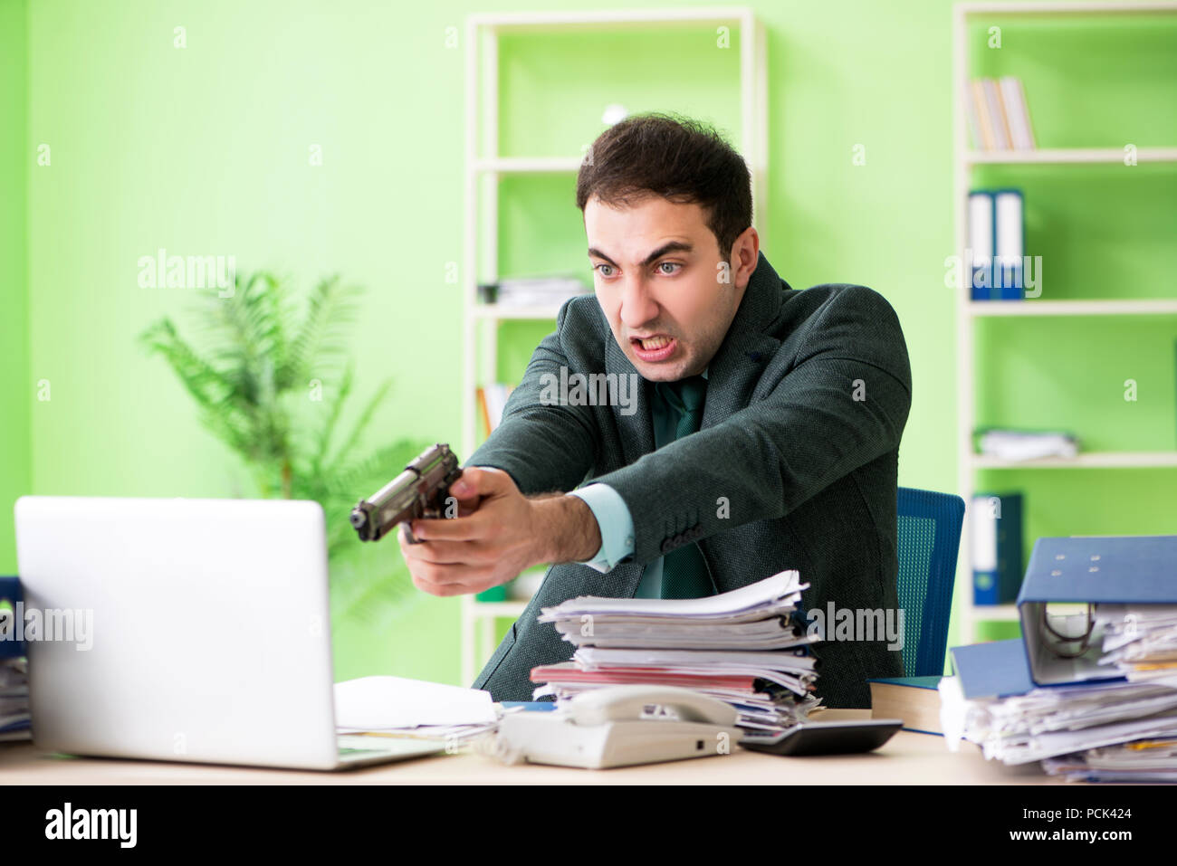 Businessman angry with excessive work sitting in the office Stock Photo ...