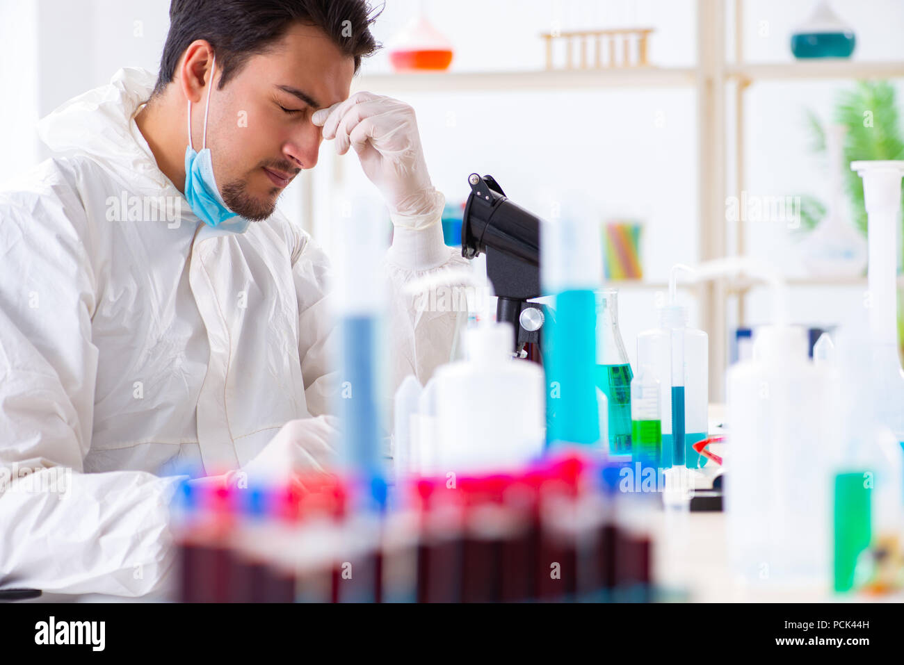 Young chemist student working in lab on chemicals Stock Photo - Alamy