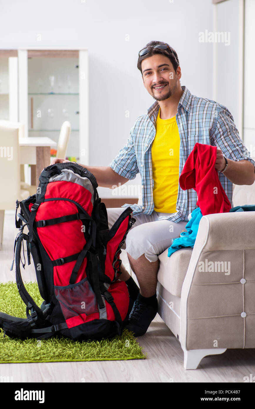 Backpacker packing for his trip Stock Photo - Alamy