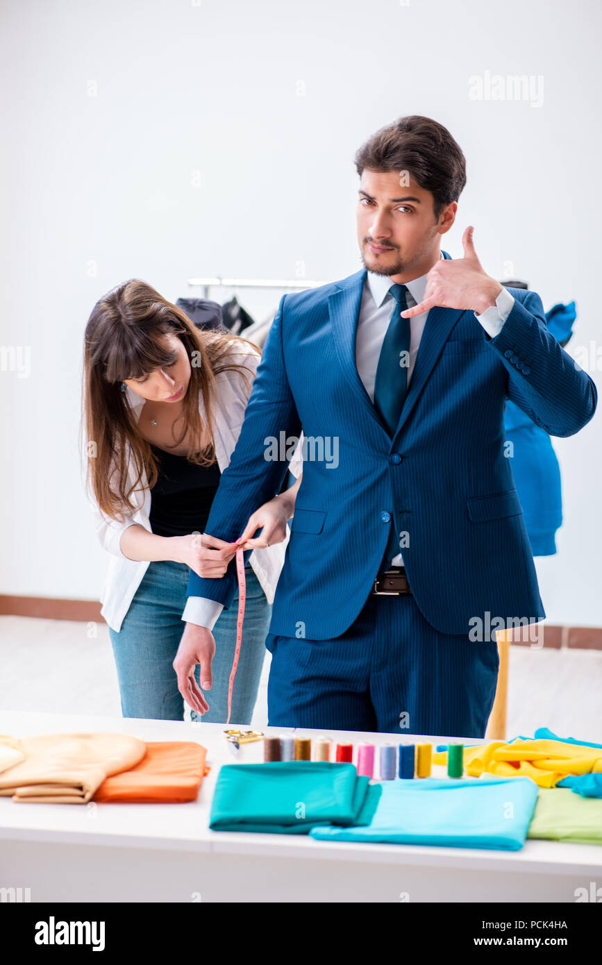 Professional tailor taking measurements for formal suit Stock Photo - Alamy
