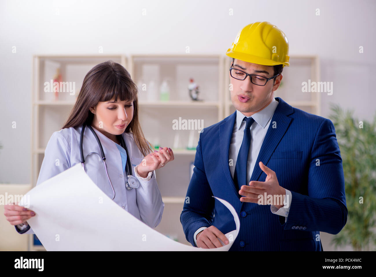 Doctor discussing new hospital plan with architect Stock Photo - Alamy