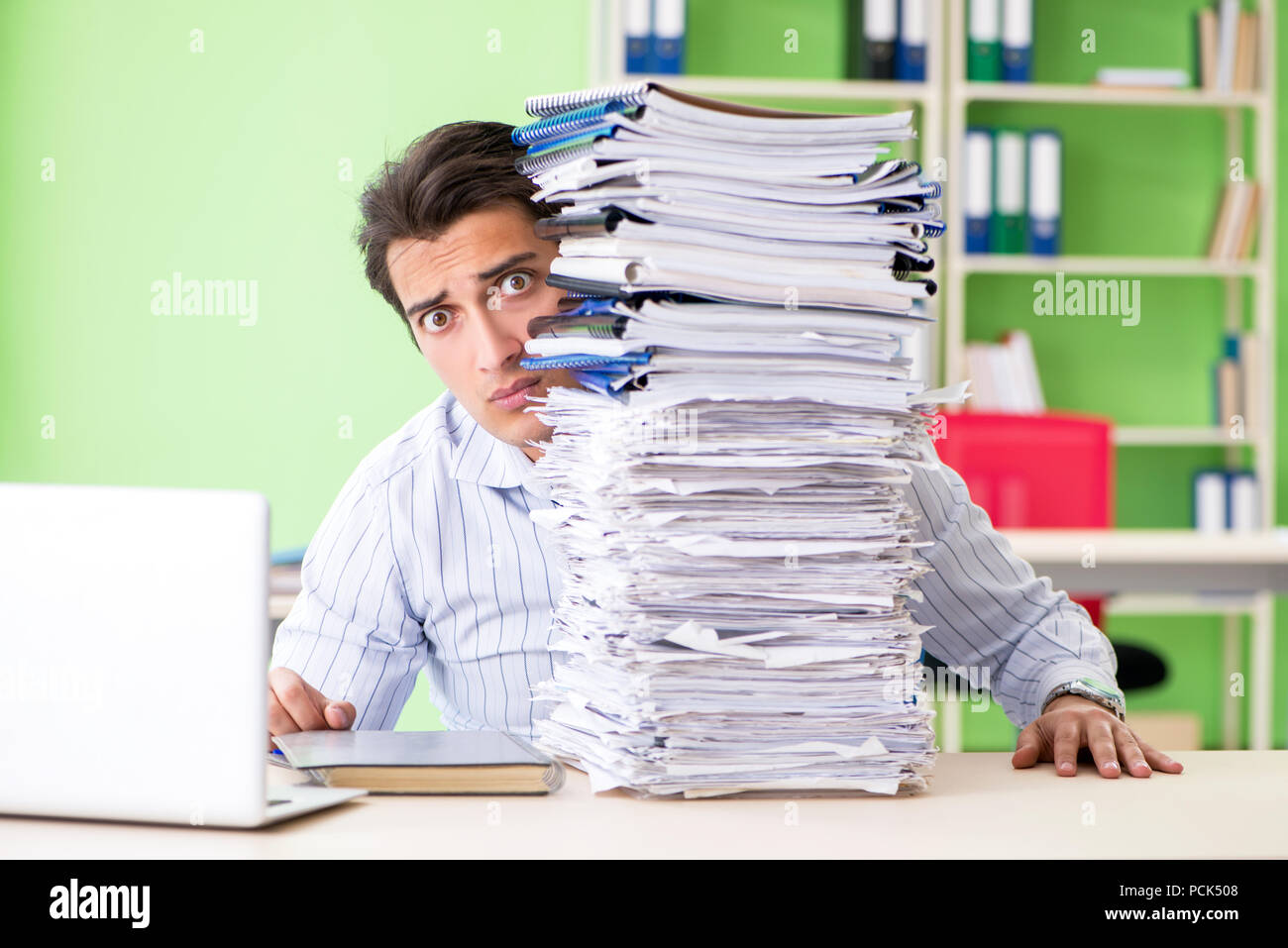 Businessman having problems with paperwork and workload Stock Photo - Alamy