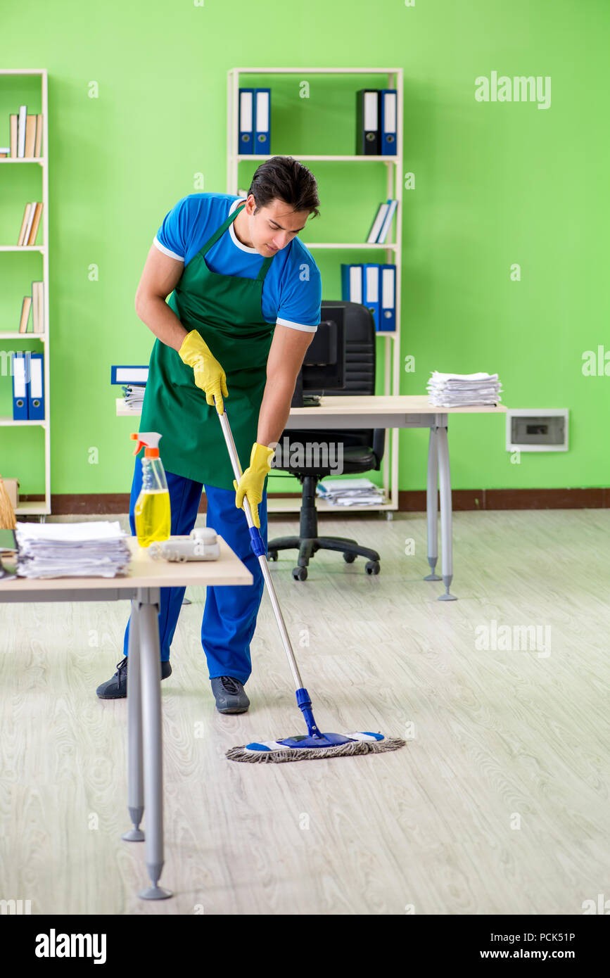 Male handsome professional cleaner doing mopping in the office Stock ...