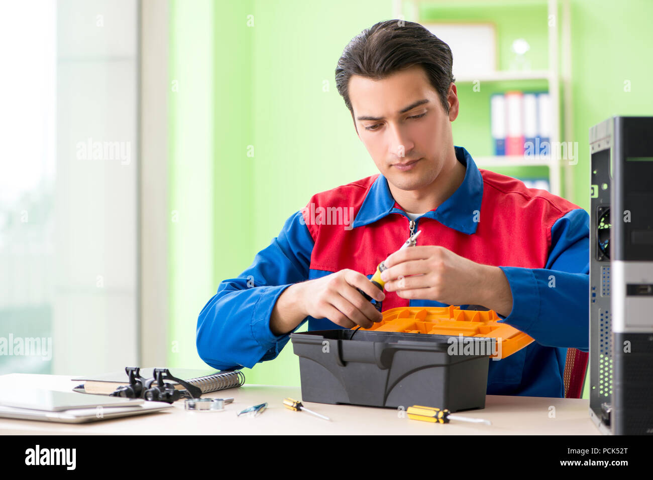 Computer engineer repairing broken desktop Stock Photo - Alamy