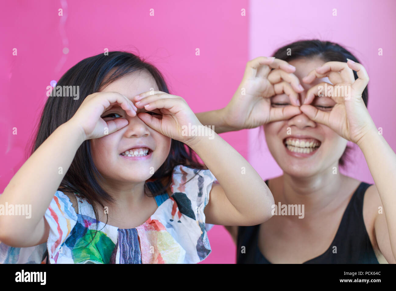 An Oriental Beauty And Her Lovely Daughter,a Smiling Chinese Mother And