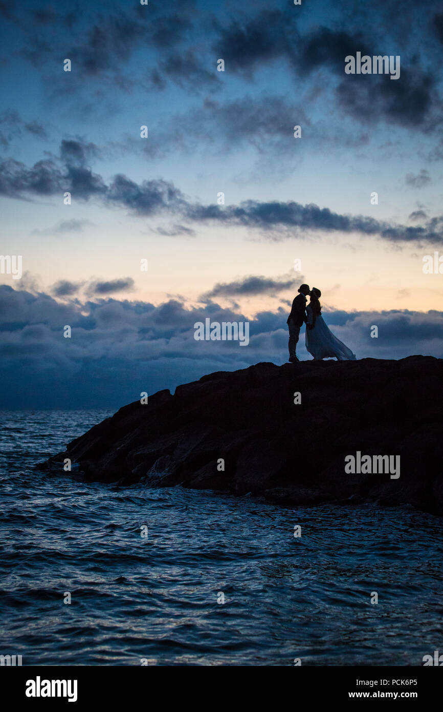 Newly married couple posing for photographs at sunset in Australia ...
