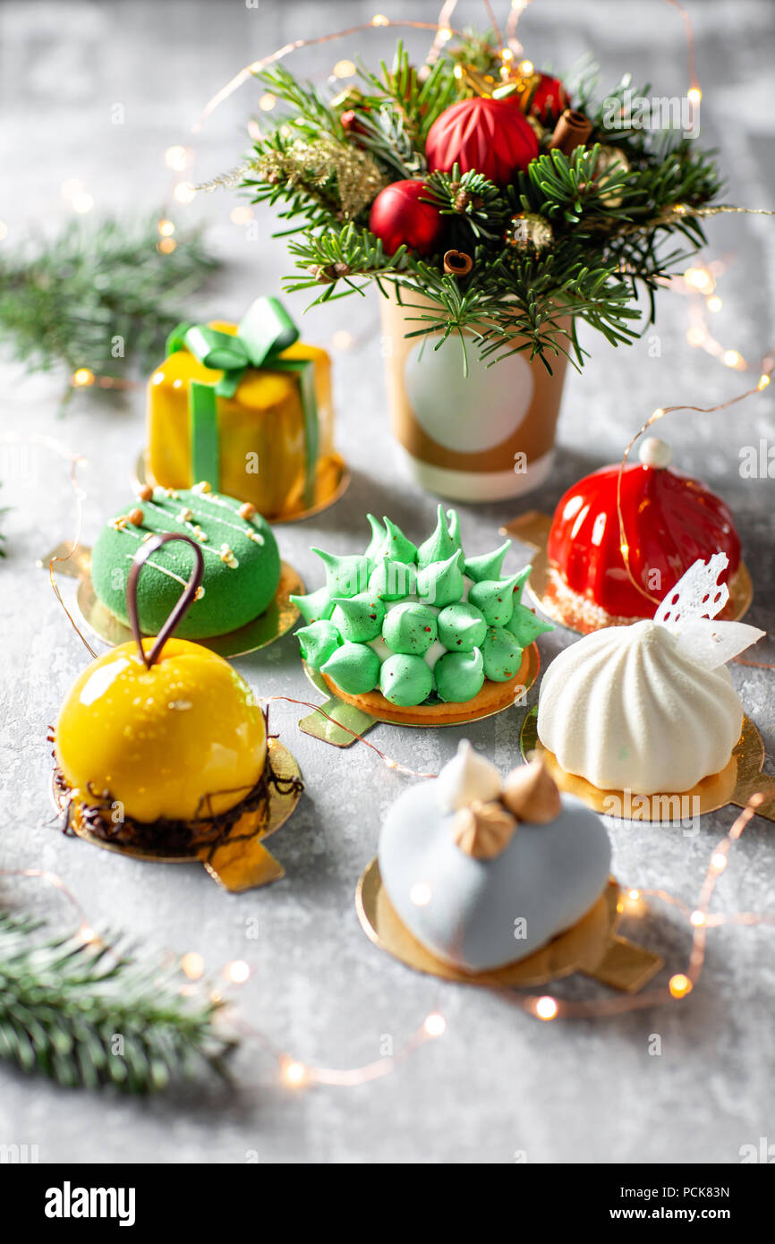 Merry Christmas card. Variety of sweet delicious cakes. Fir branches on ...