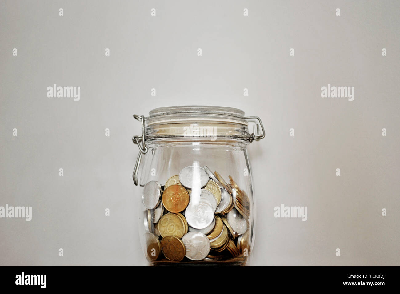 Coins in a jar Stock Photo - Alamy