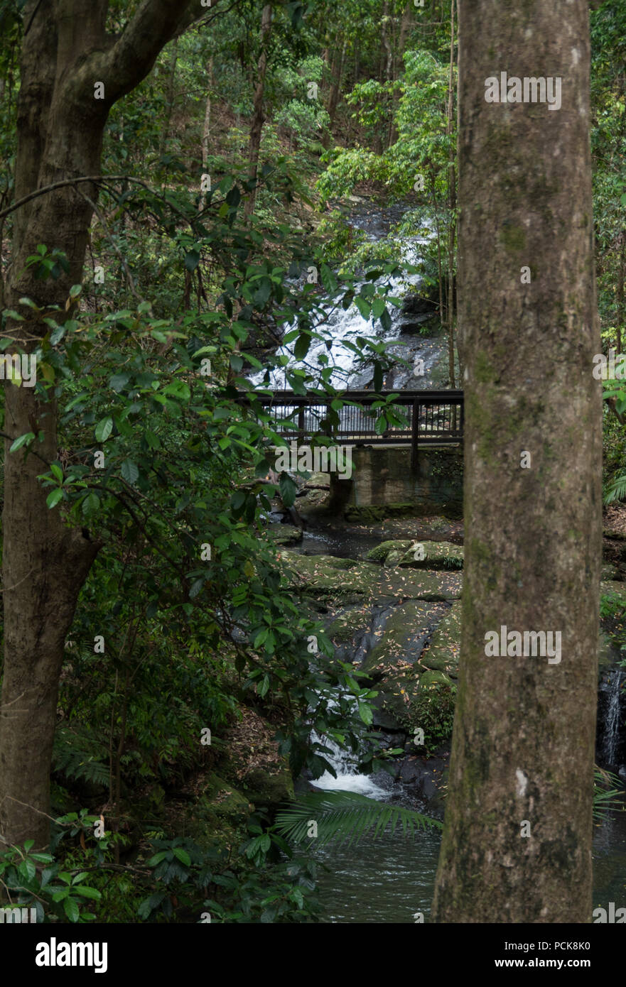 Waterfall behind a bridge Stock Photo - Alamy