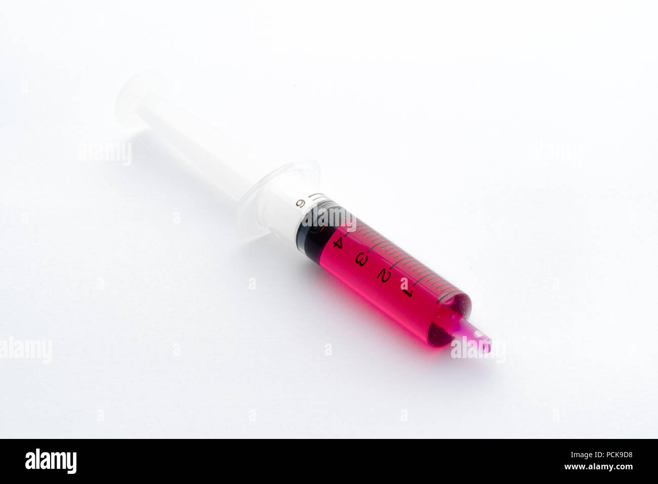 Studio shot of syringe containing liquid medicine for kid isolated on ...