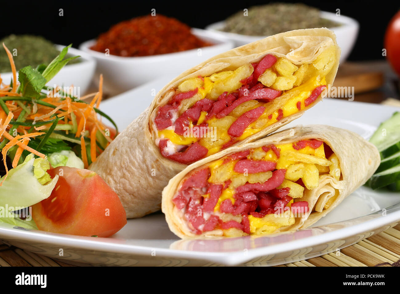 A sliced tortilla wrap a rollup of flatbread with salami and corn ...