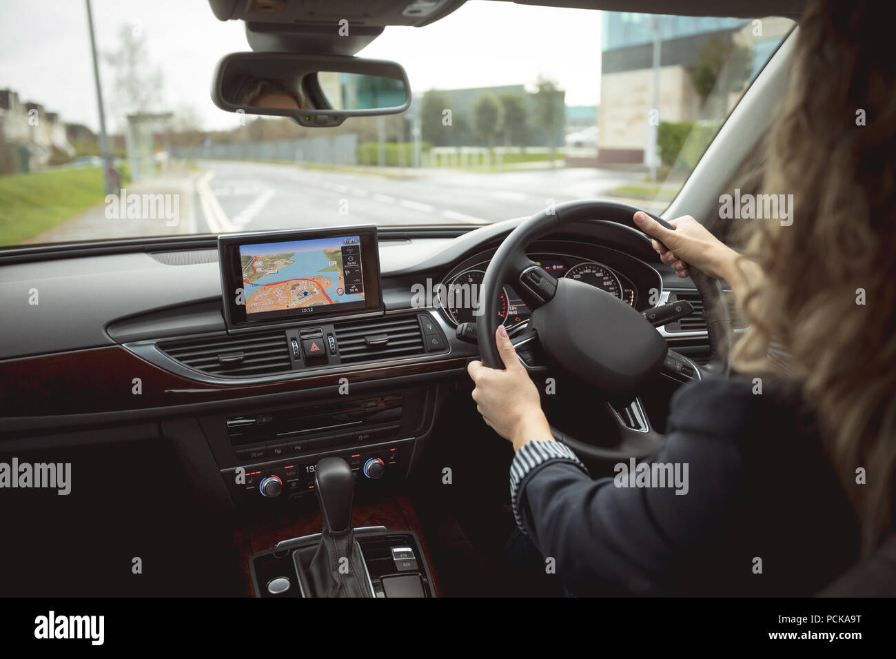 Female executive driving car on the street Stock Photo - Alamy