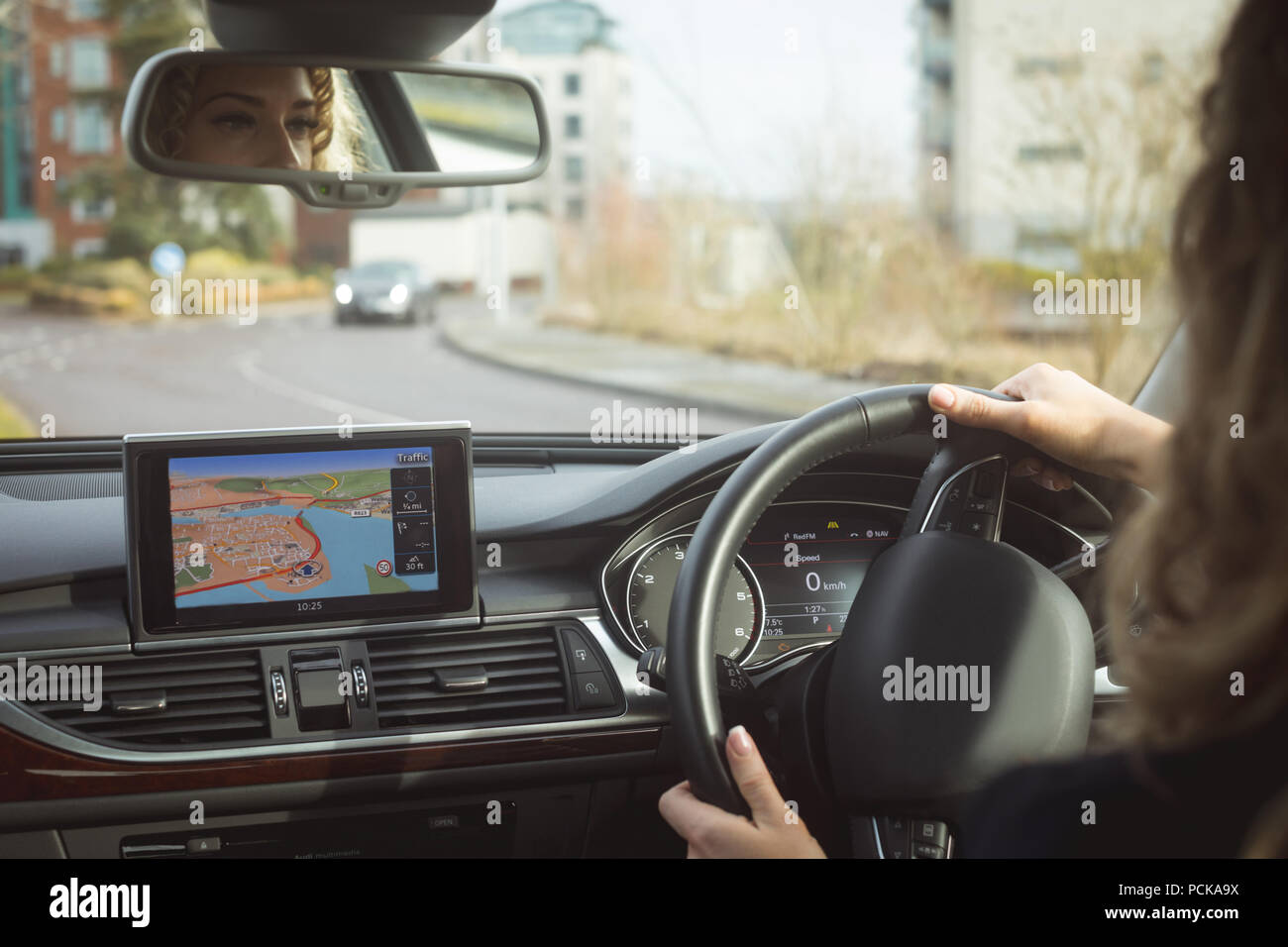 Female executive driving car on the street Stock Photo - Alamy