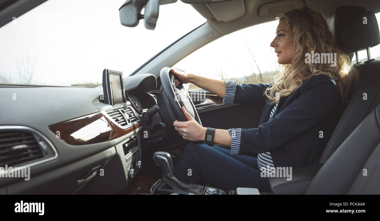 Female executive driving a car Stock Photo - Alamy