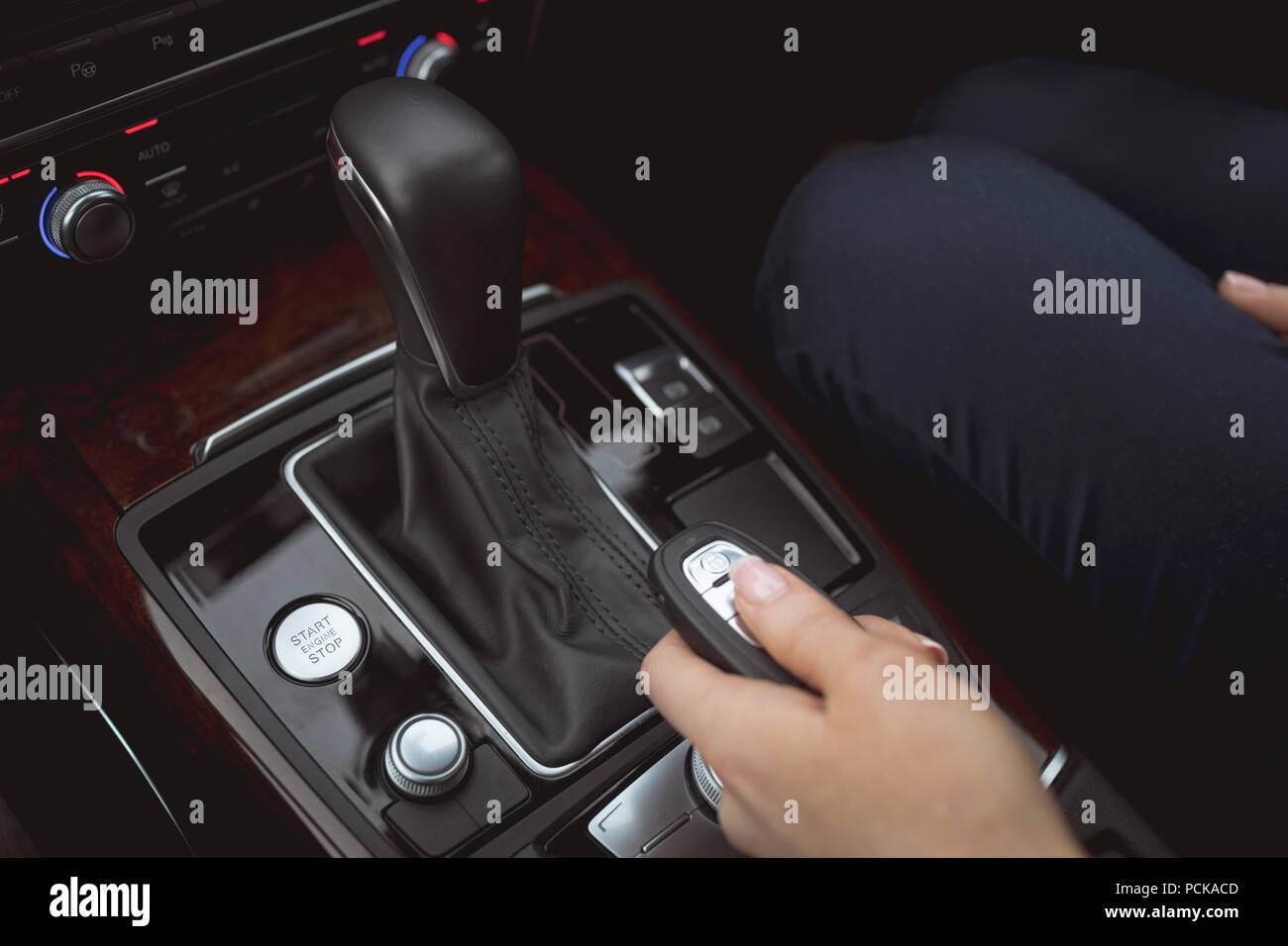 Female executive using car remote in a car Stock Photo - Alamy