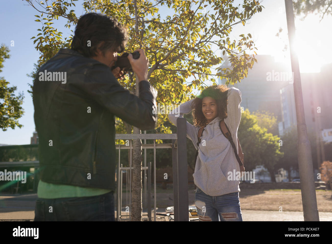 Photographer taking pictures of a model in street Stock Photo - Alamy