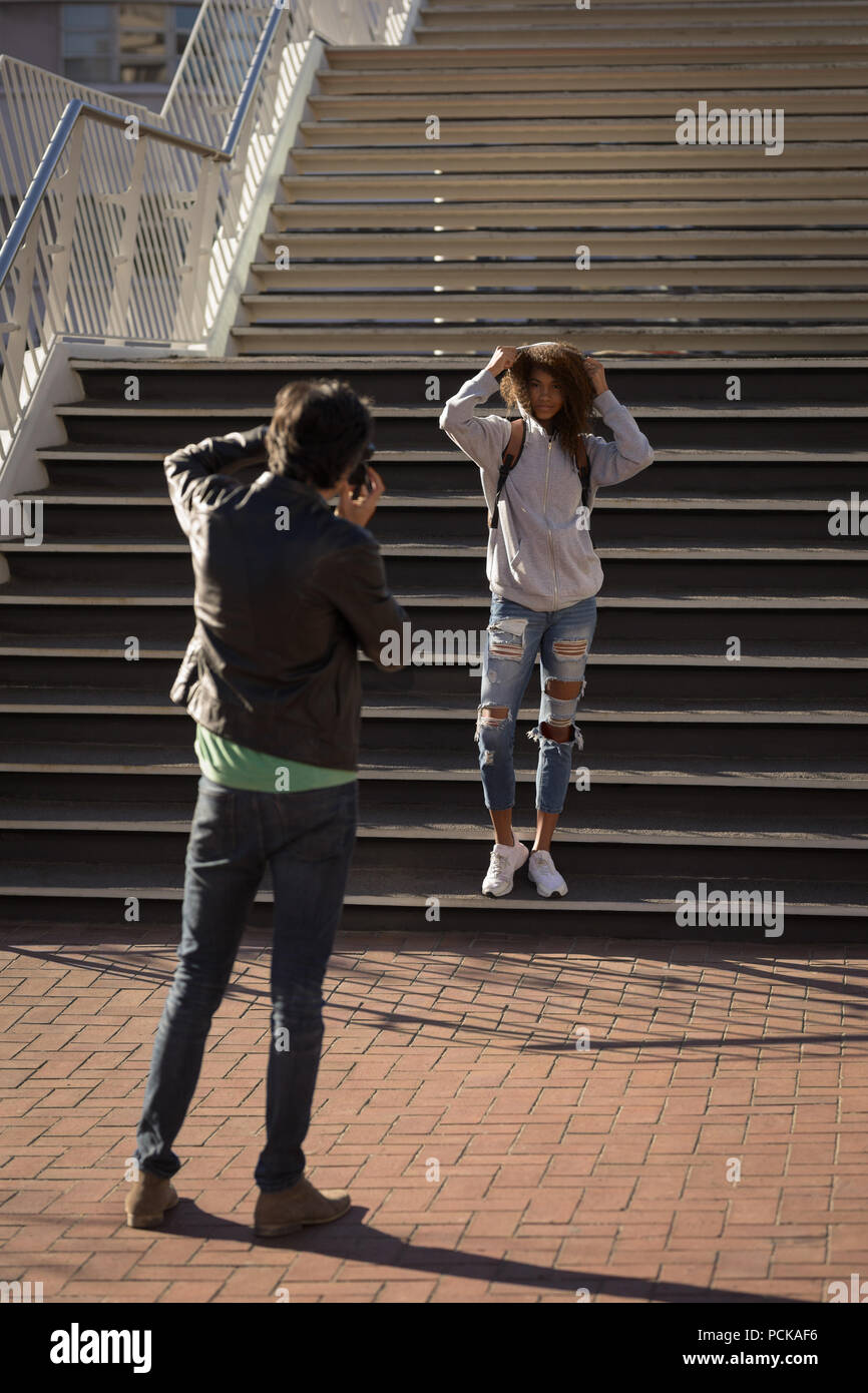 Photographer taking pictures of a model in street Stock Photo - Alamy