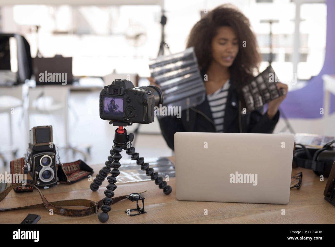 Pretty photographer working at laptop Stock Photo - Alamy