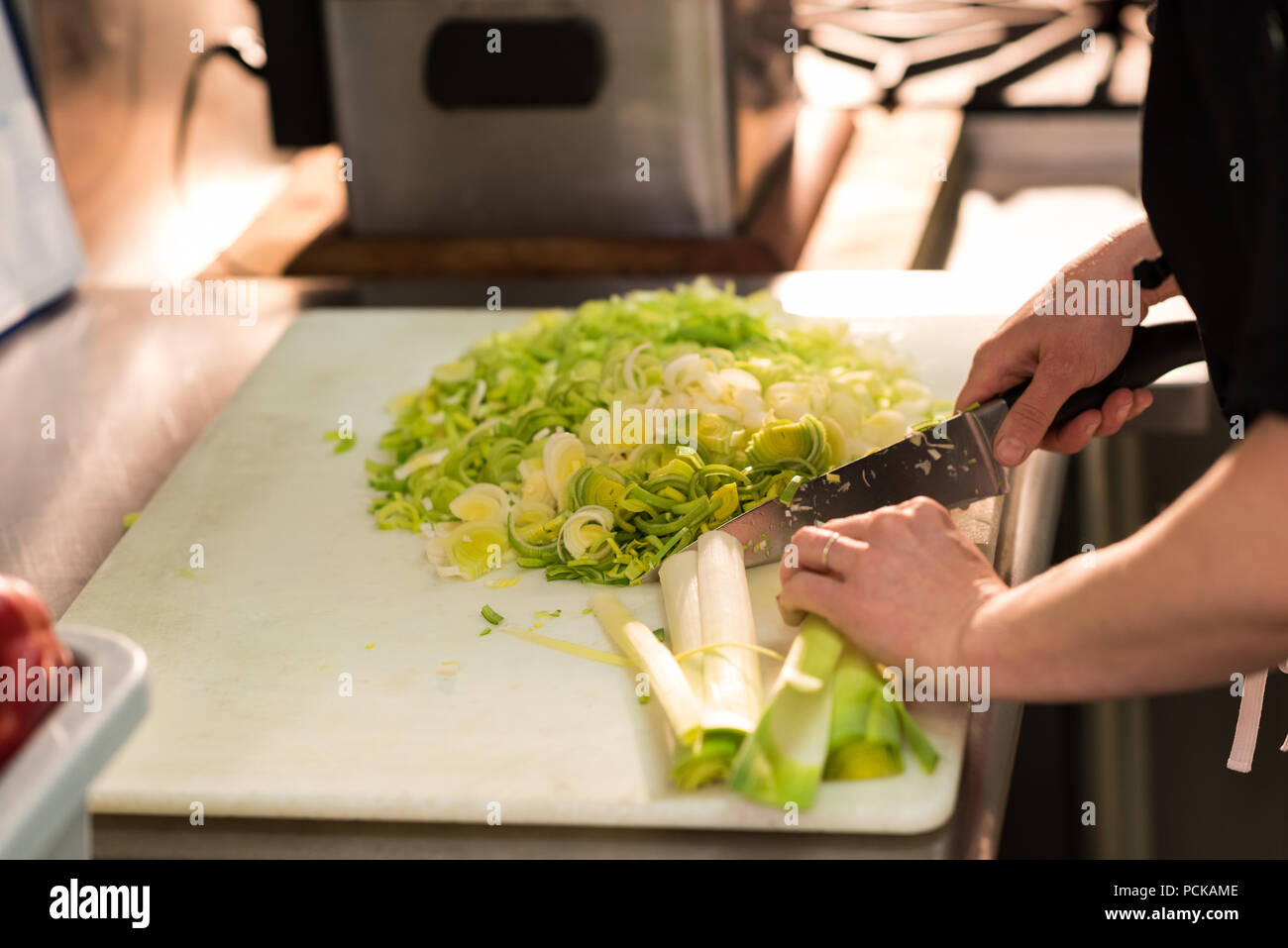 Chef chopping vegetable in a commercial kitchen Stock Photo - Alamy