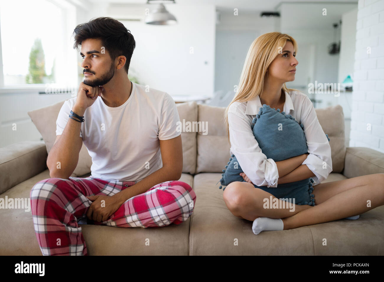Worried couple having problems in bedroom Stock Photo - Alamy