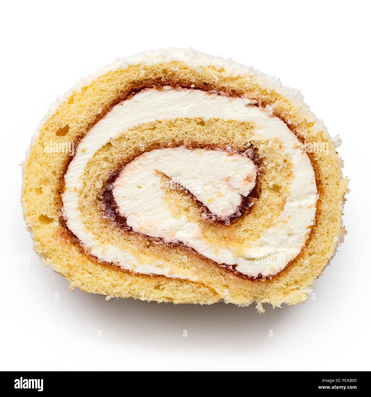 Slice of coconut swiss roll with cream and jam isolated on white from ...