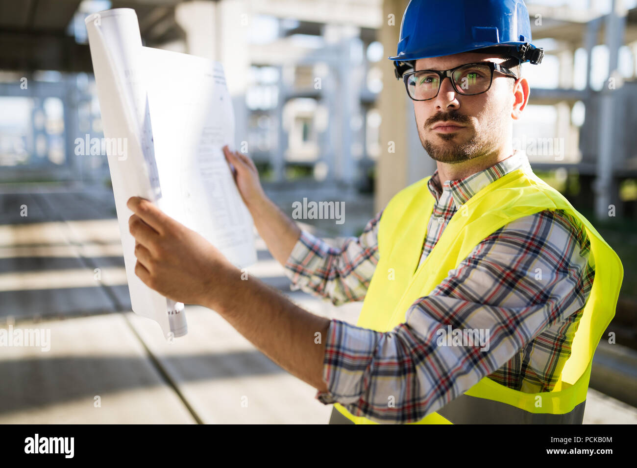 Picture of construction site engineer looking at plan Stock Photo - Alamy