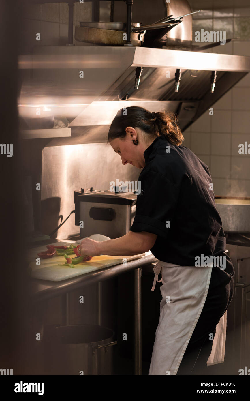Chef chopping vegetable in the commercial kitchen Stock Photo - Alamy