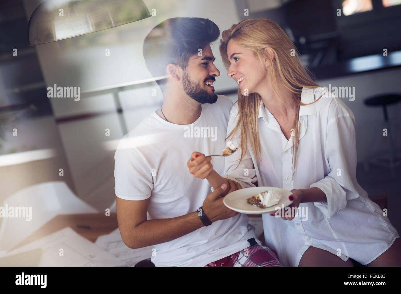 Beautiful girlfriend is feeding her handsome lover Stock Photo - Alamy