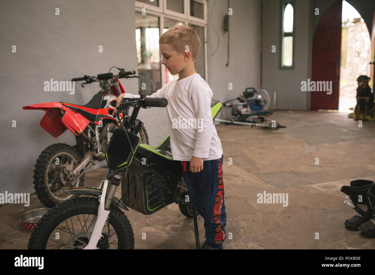 Little kid standing with bike Stock Photo - Alamy