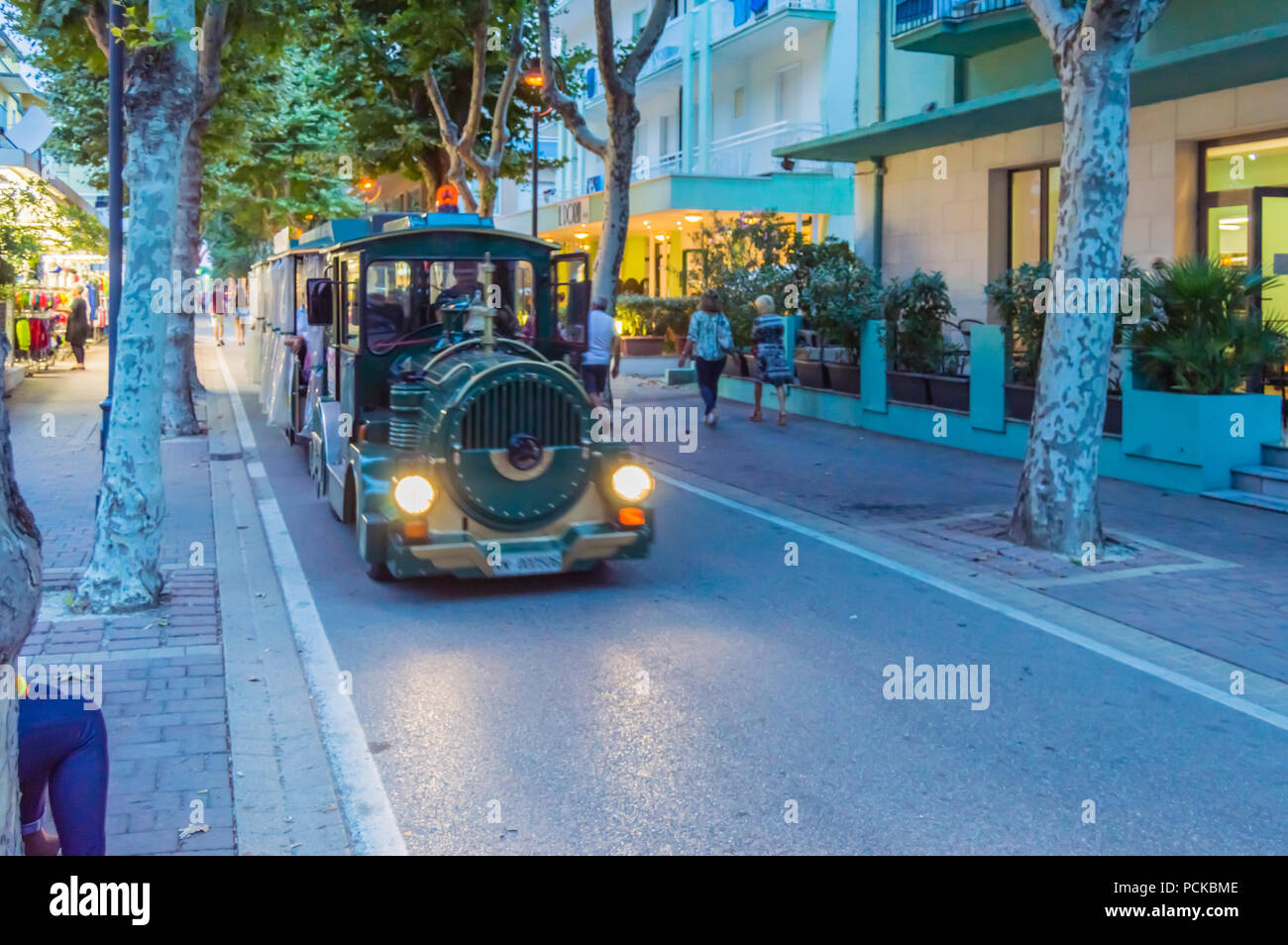 Locomotive of a small tourist train in the streets of Igea Marina near ...