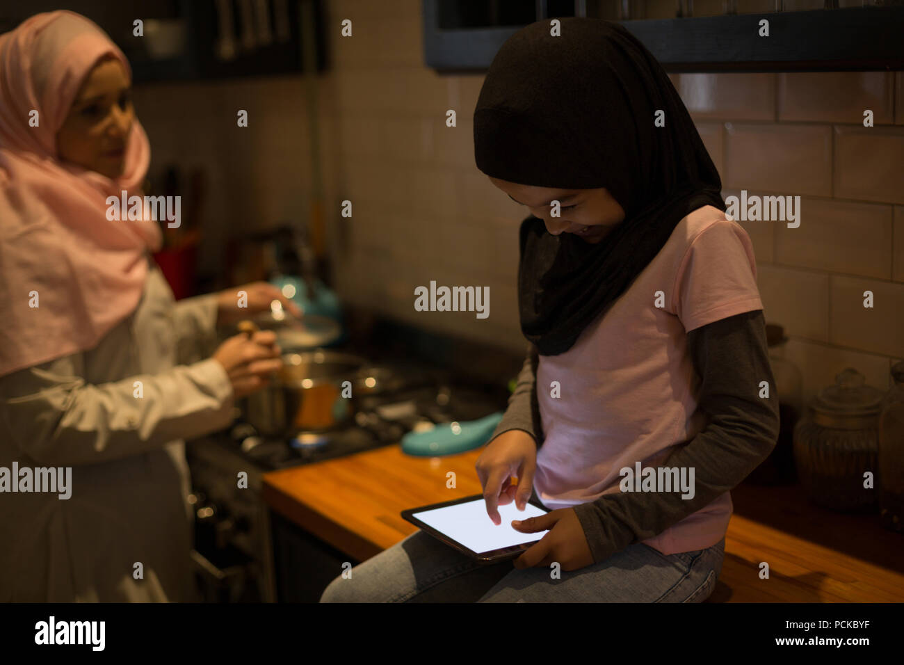 Muslim mother and child cooking hi-res stock photography and images - Alamy