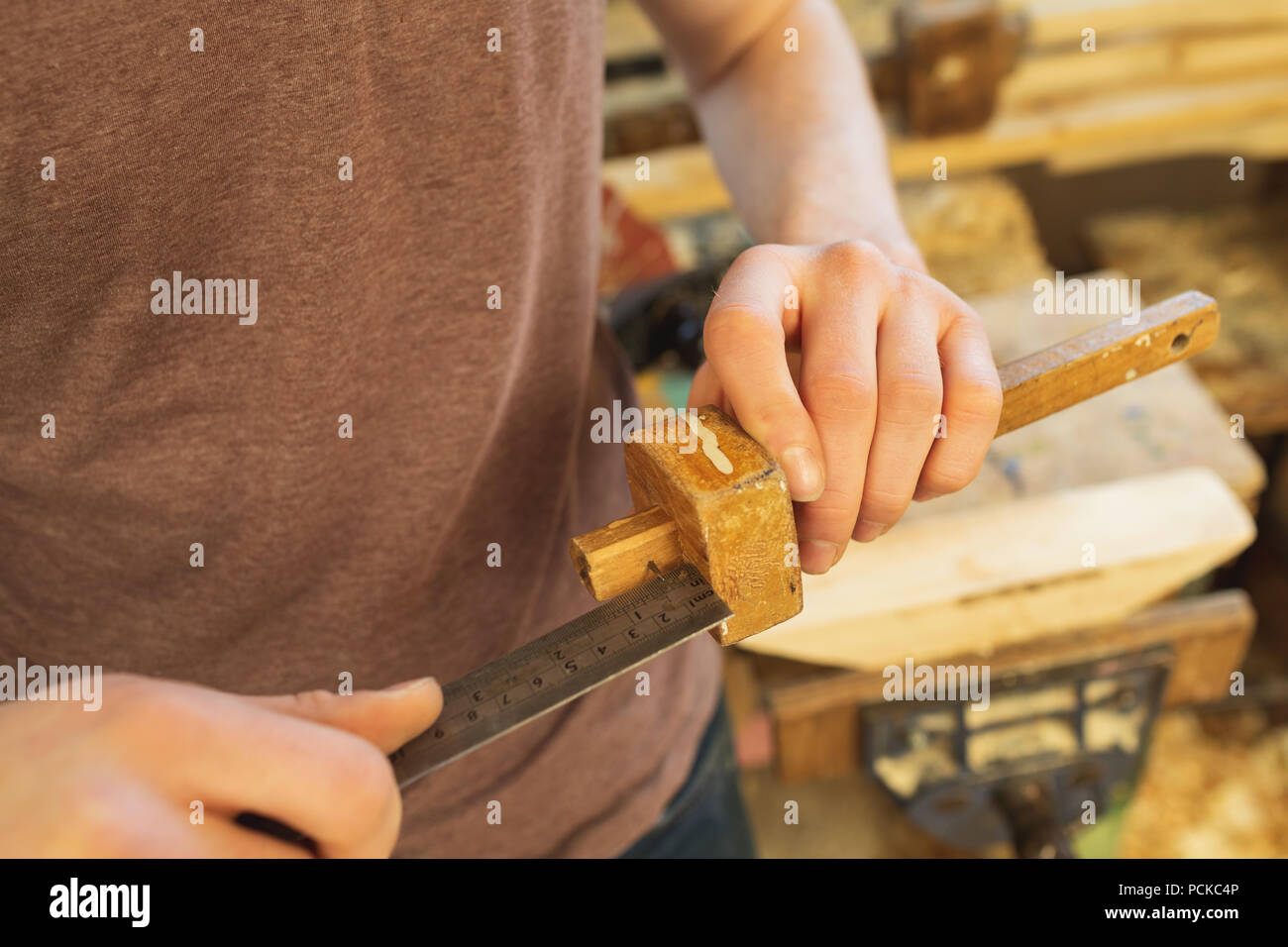 Male carpenter measuring marking gauge with ruler Stock Photo - Alamy